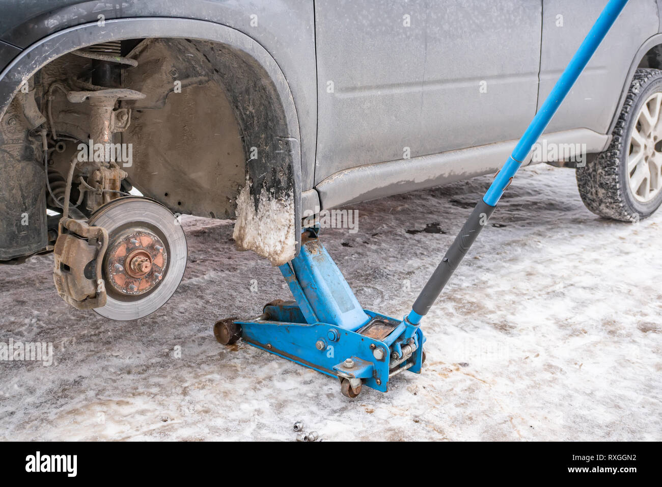 The working process of removing the wheels from the car on the street ...