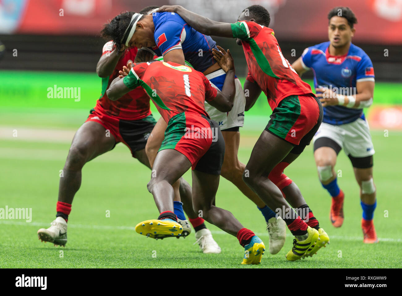 Vancouver, Canada. 9 March 2019. Tofatu Solia (blue) of Samoa, being ...