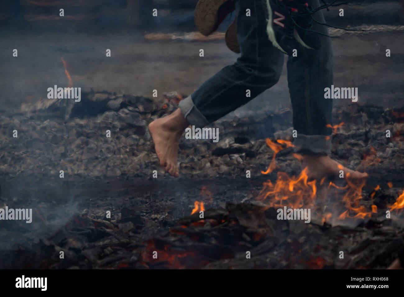 Tokyo, Japan. 10th March 2019. A faithful walks on ashes during a fire ...