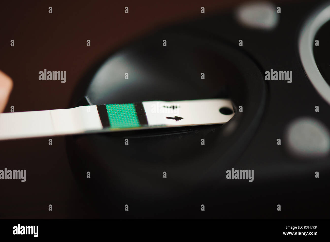 Diabetic patient doing glucose level blood test using ultra mini ...