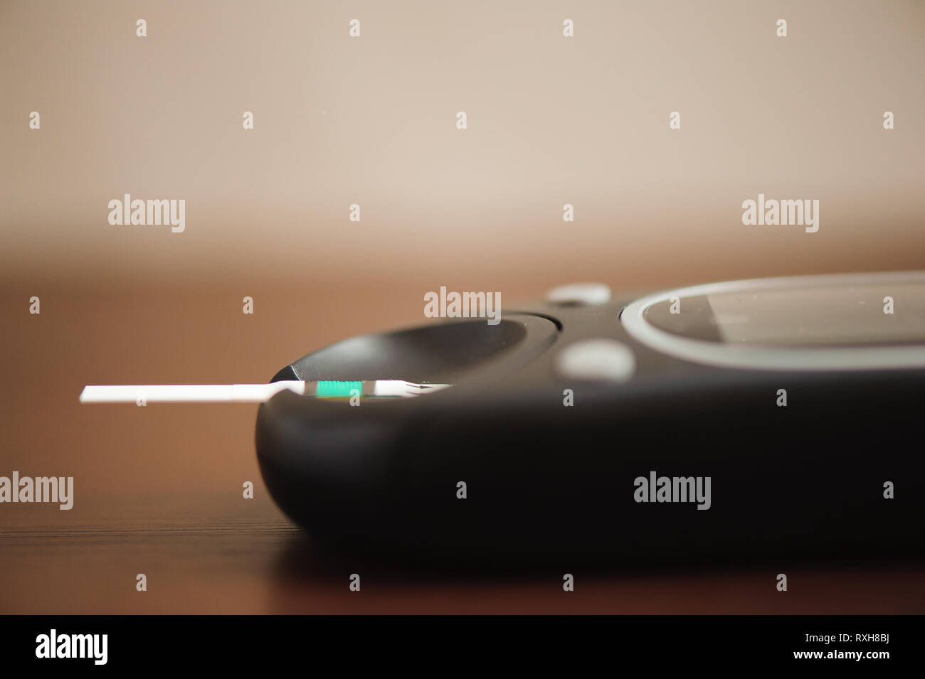 Diabetic patient doing glucose level blood test using ultra mini ...