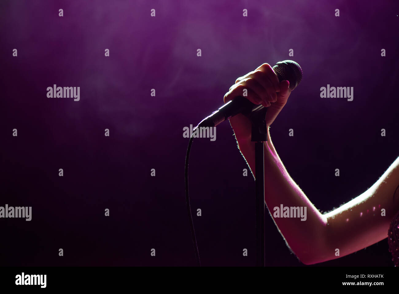 Microphone in hand singer on stage. Live music background. Microphone ...