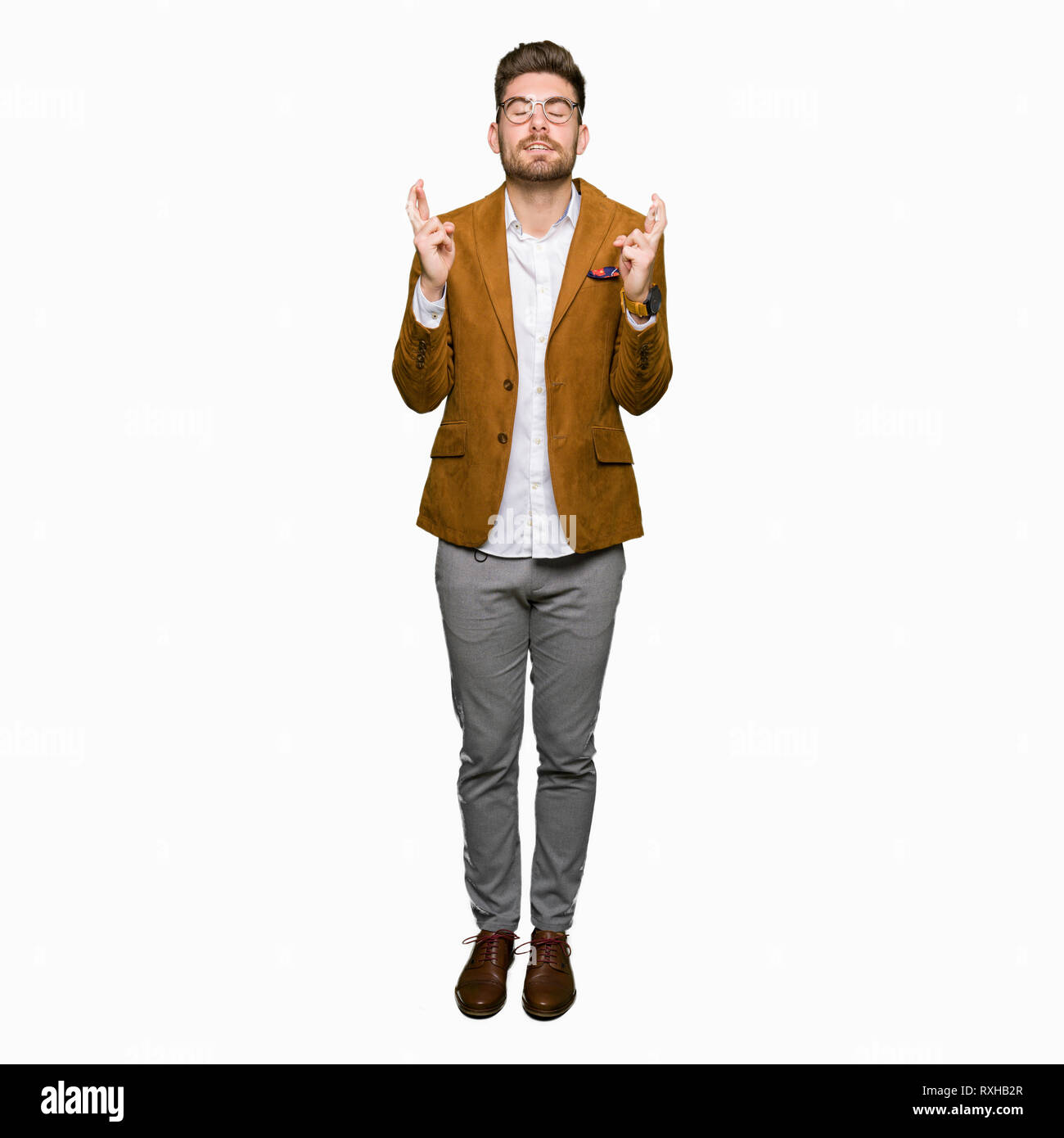 Young hopeful man crossing Cut Out Stock Images & Pictures - Alamy