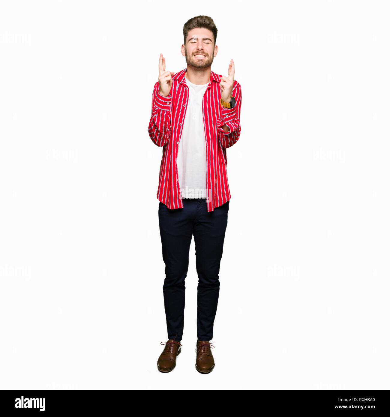 Crossed fingers hispanic man Cut Out Stock Images & Pictures - Alamy