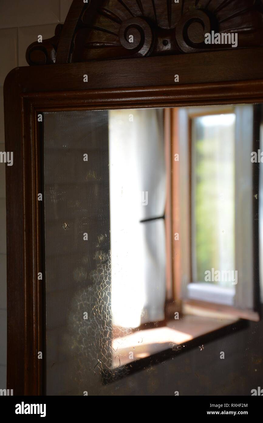 one open window reflected in an old wooden mirror Stock Photo - Alamy