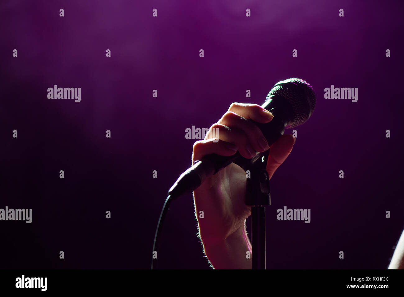 Microphone in hand singer on stage. Live music background. Microphone ...