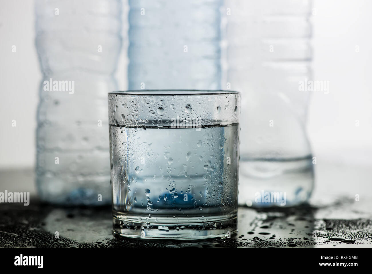 A Glass of water with empty plastic bottles Stock Photo - Alamy