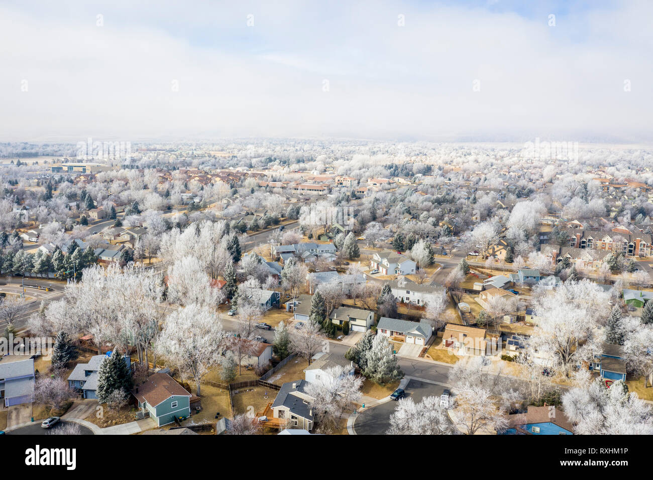 hazy and frosty winter morning over city of Fort Collins and foothills ...