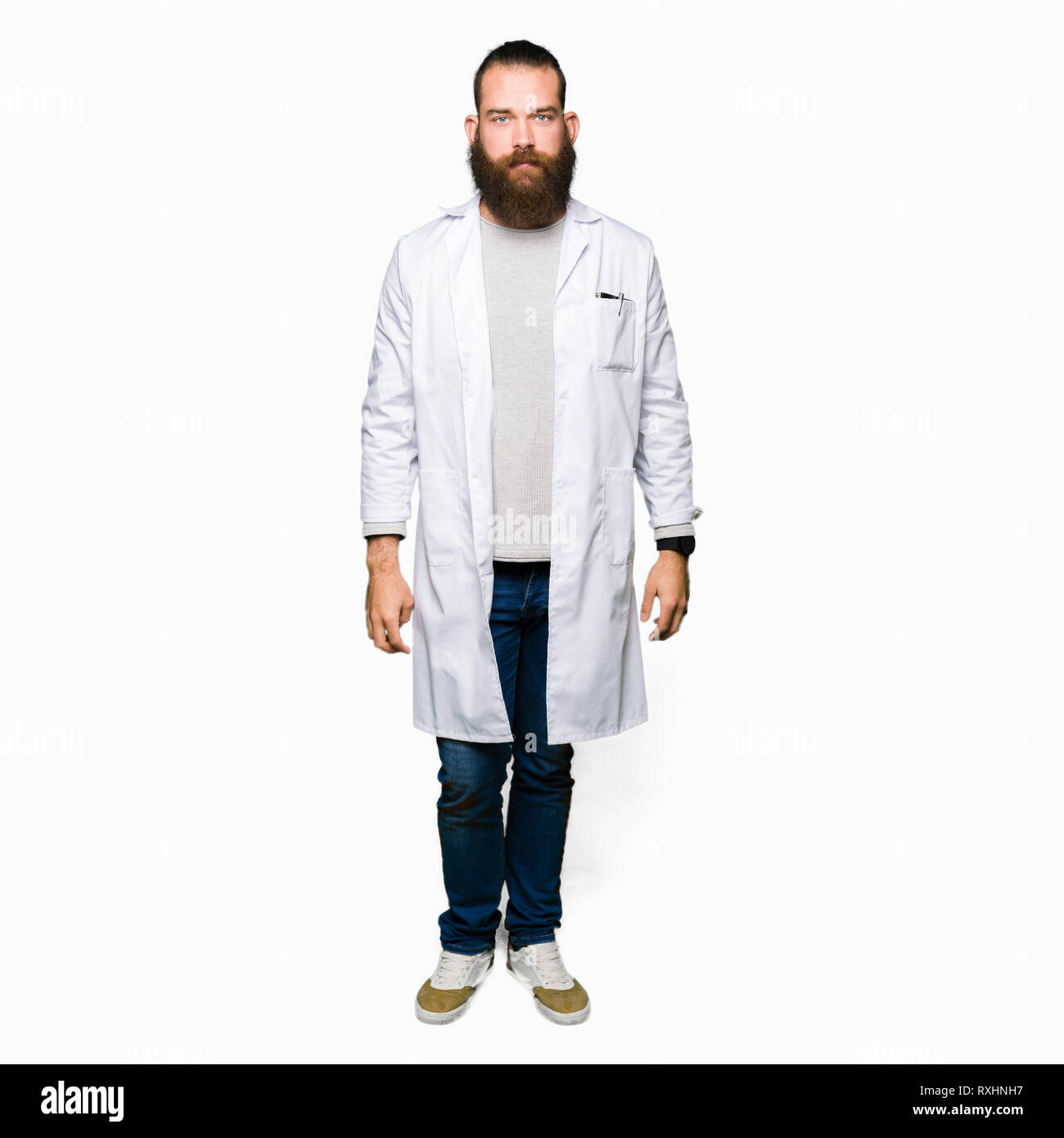 Young blond scientist man wearing white coat with serious expression on ...