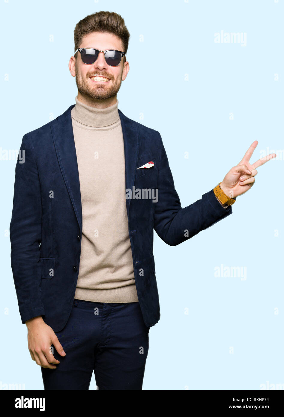 Young handsome elegant man wearing sunglasses smiling with happy face ...