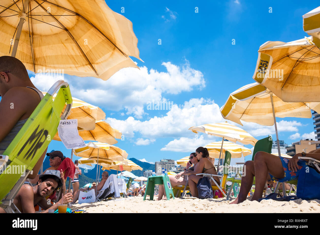 RIO DE JANEIRO - FEBRUARY 10, 2017: Beachgoers relax in beach chairs on ...