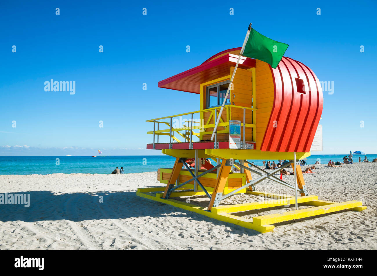 Bright scenic fine weather view of green flag flying on a lifeguard ...