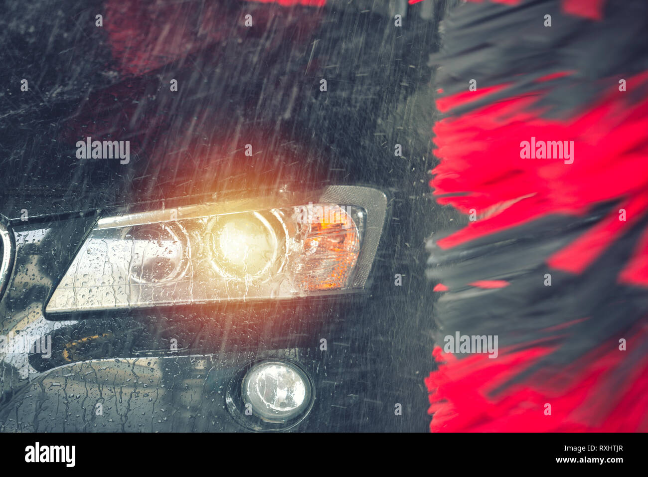 Automatic car wash in action. Car wash concept. Automated technology ...