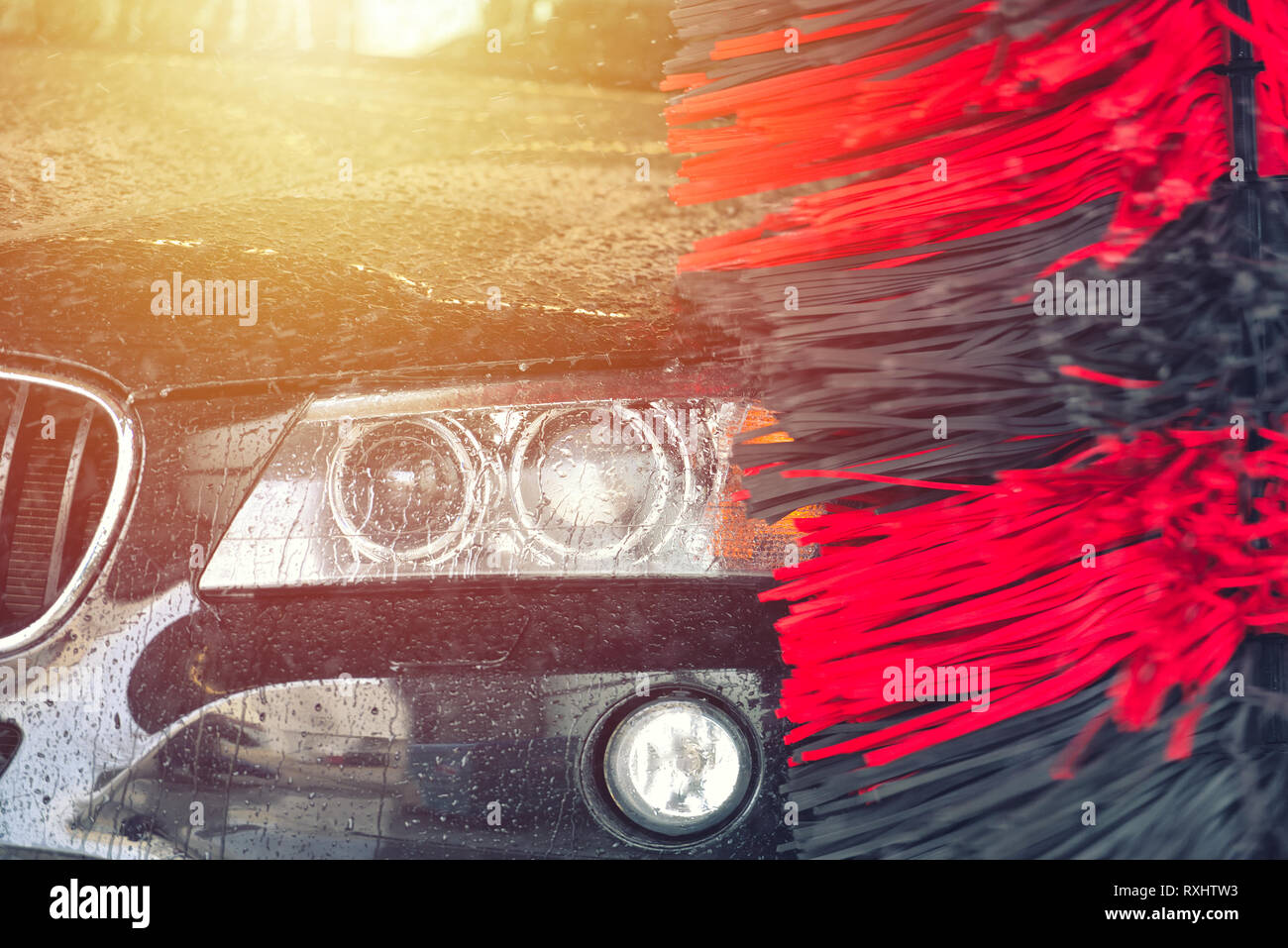 Automatic car wash in action. Car wash concept. Automated technology ...