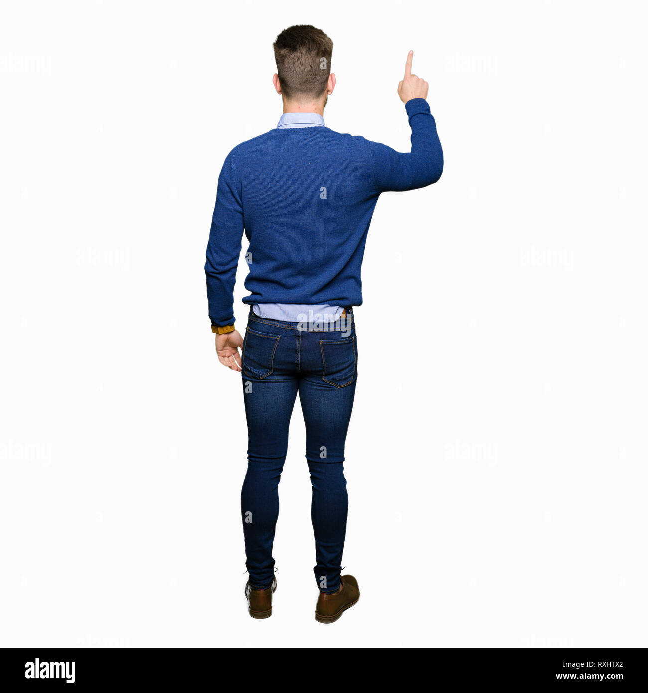 Young handsome bussines man Posing backwards pointing behind with ...