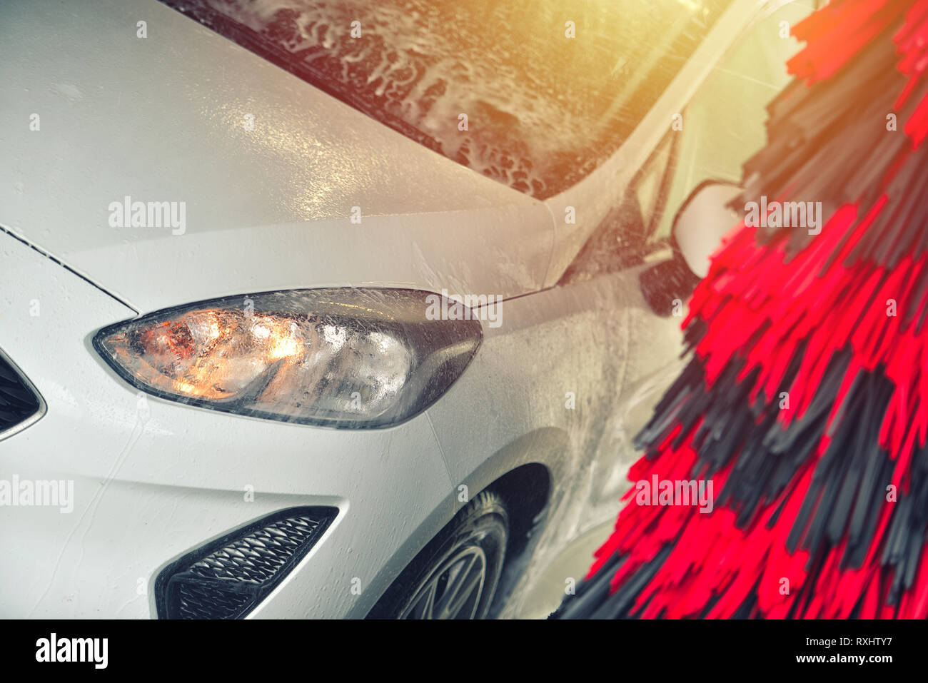 Automatic car wash in action. Car wash concept. Automated technology ...