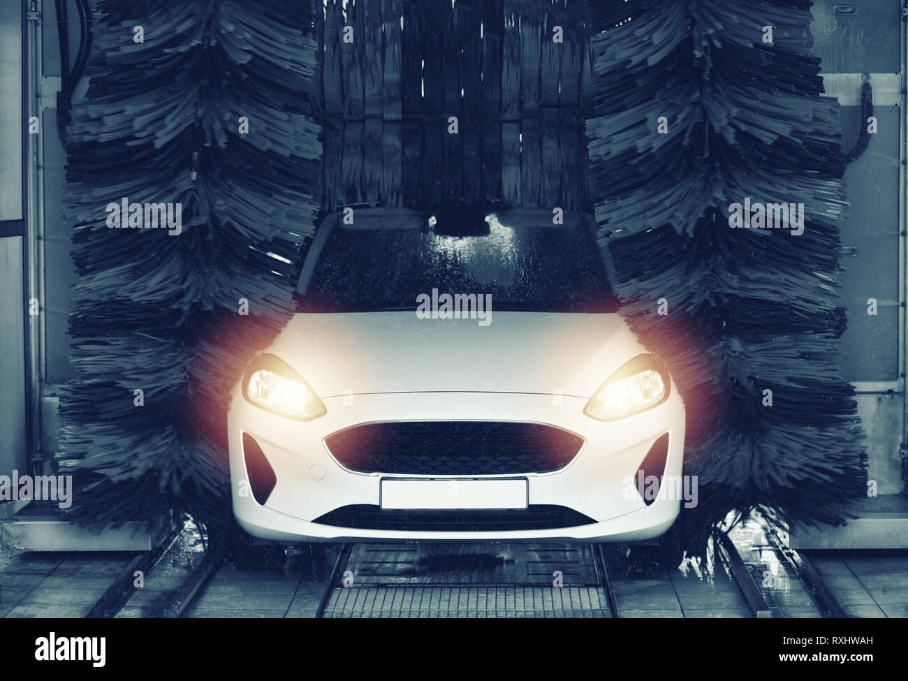 Automatic car wash in action. Car wash concept. Automated technology ...