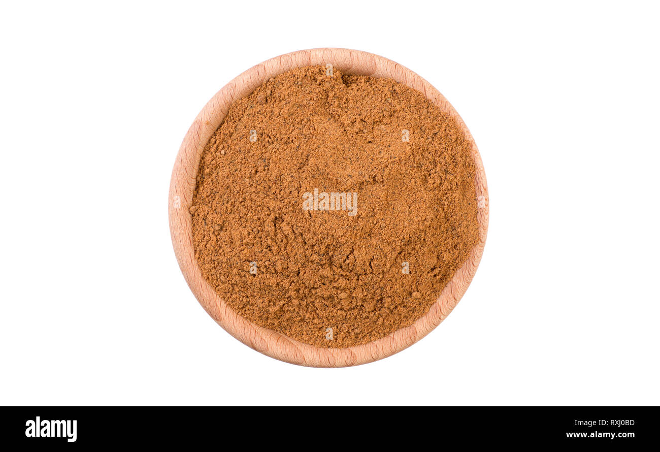 milled or ground nutmeg in wooden bowl isolated on white background ...