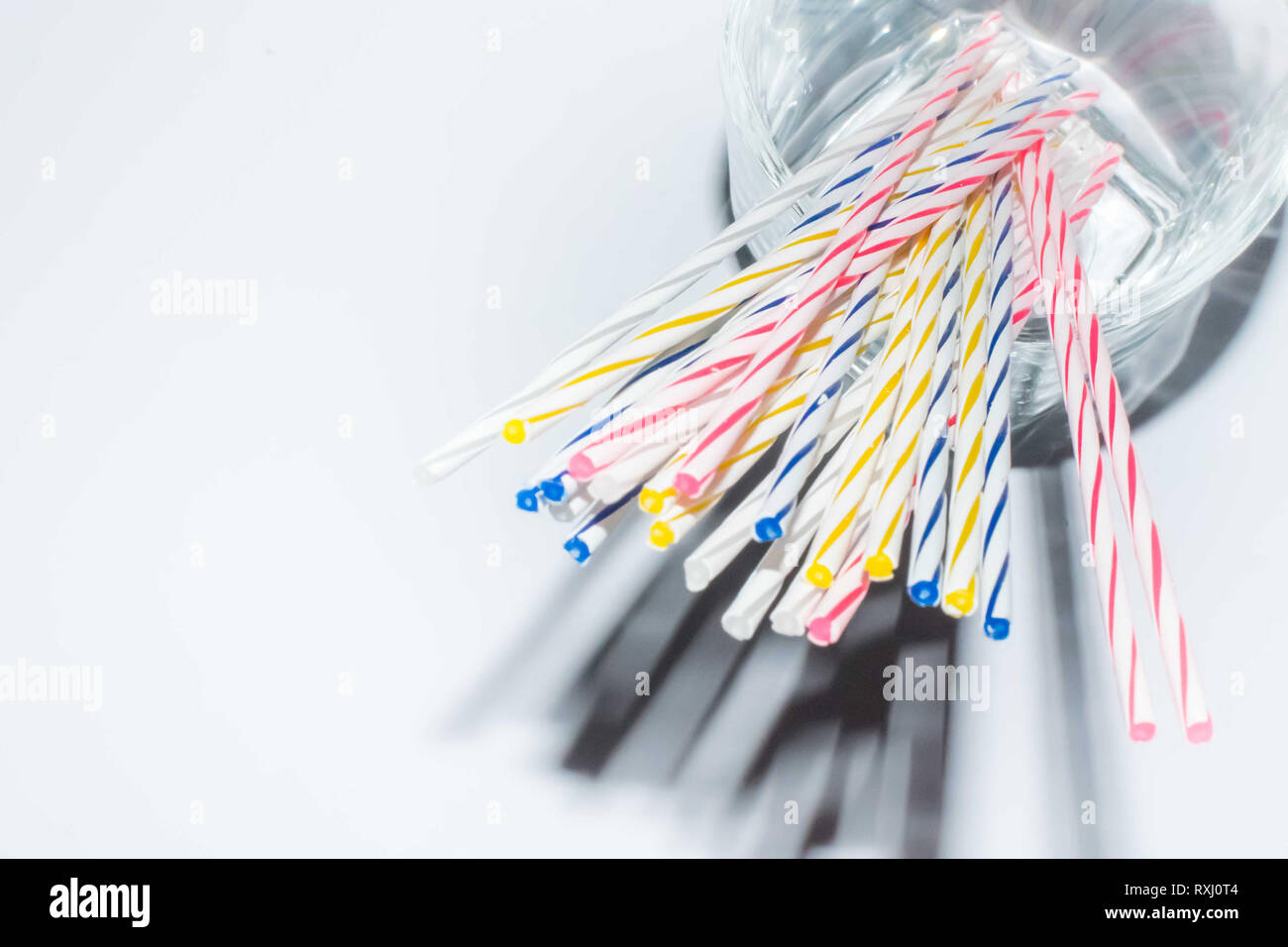 Multi-Colored Sticks on glass mug Stock Photo - Alamy