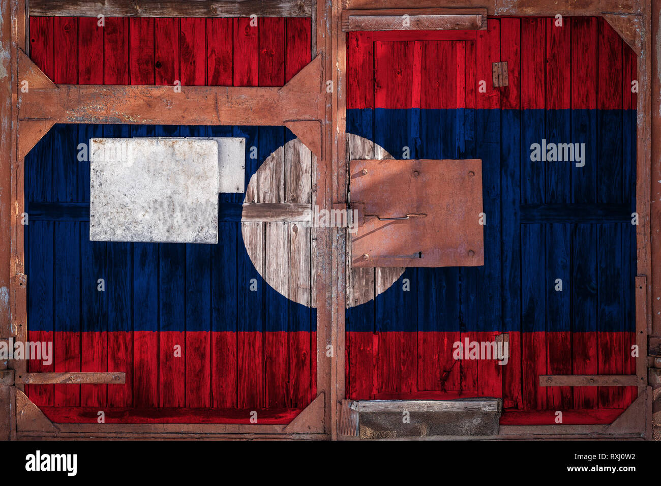 Close-up of old warehouse gate with national flag of Laos. The concept ...