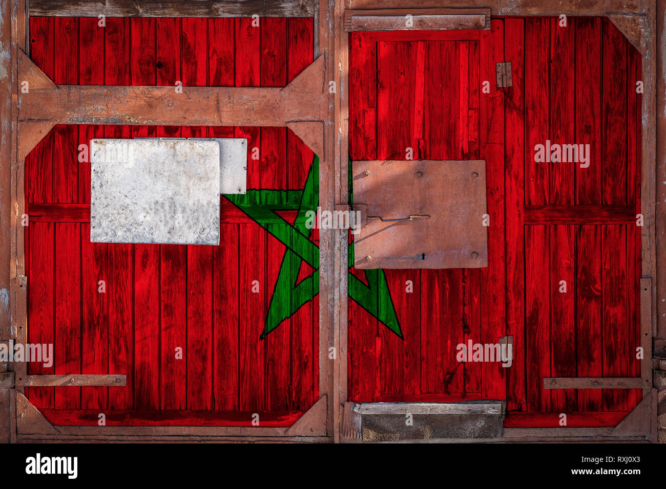 Close-up of old warehouse gate with national flag of Morocco. The ...