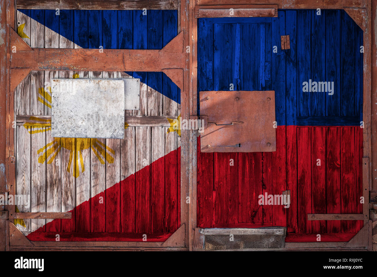 Close-up of old warehouse gate with national flag of Philippines. The ...