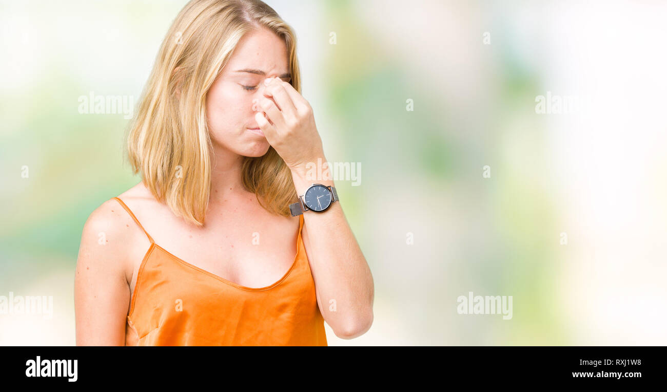 Beautiful young woman wearing orange shirt over isolated background ...