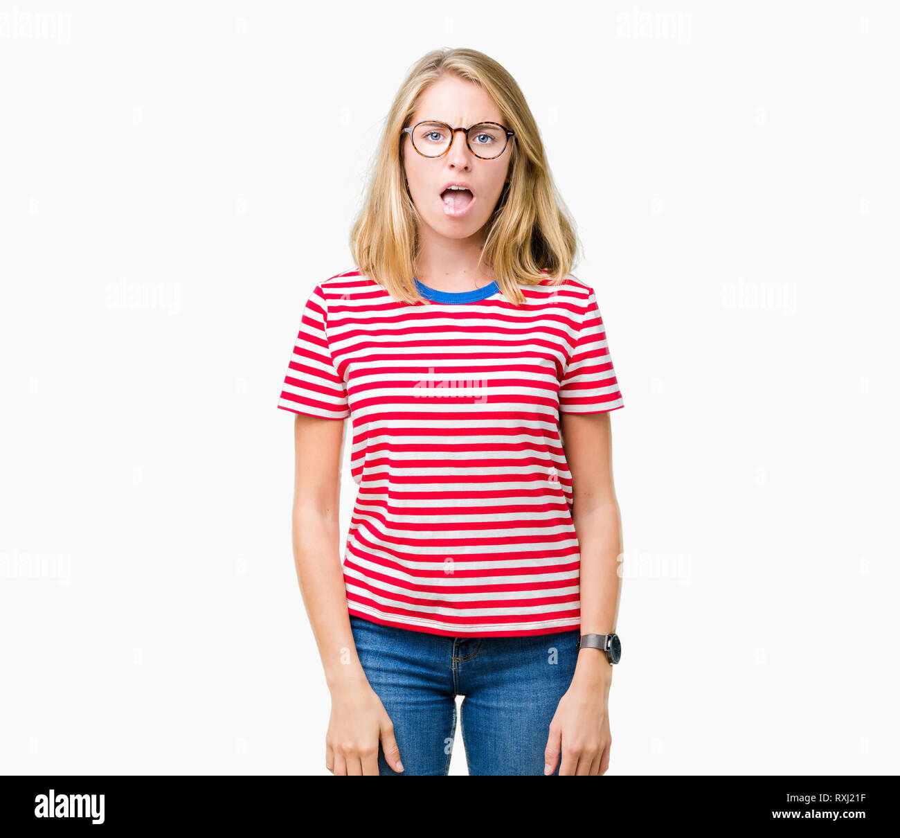Beautiful young woman wearing glasses over isolated background In shock ...