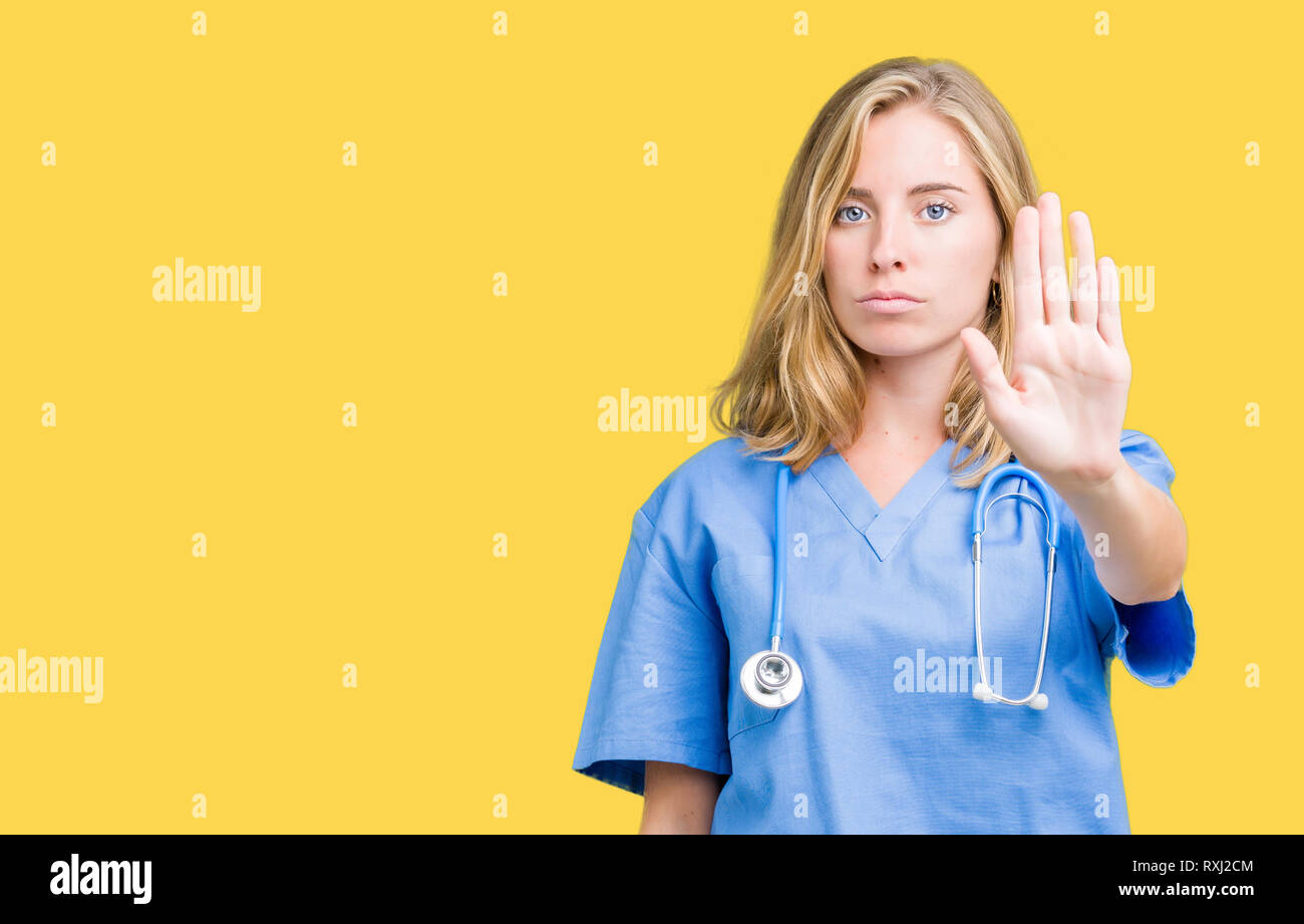 Beautiful young doctor woman wearing medical uniform over isolated ...