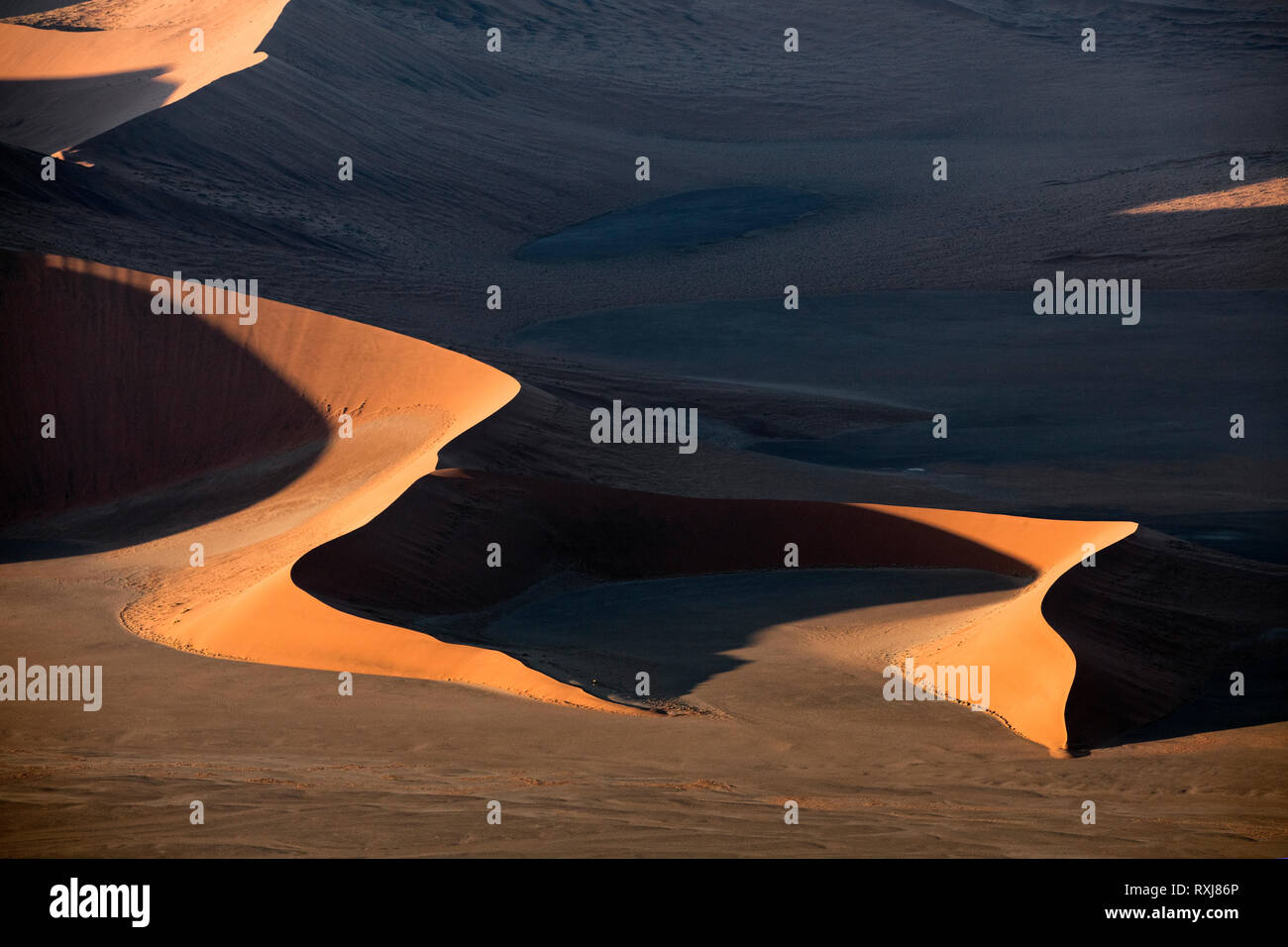 An abstract of sand dunes over the sand dunes of Namibia Stock Photo ...