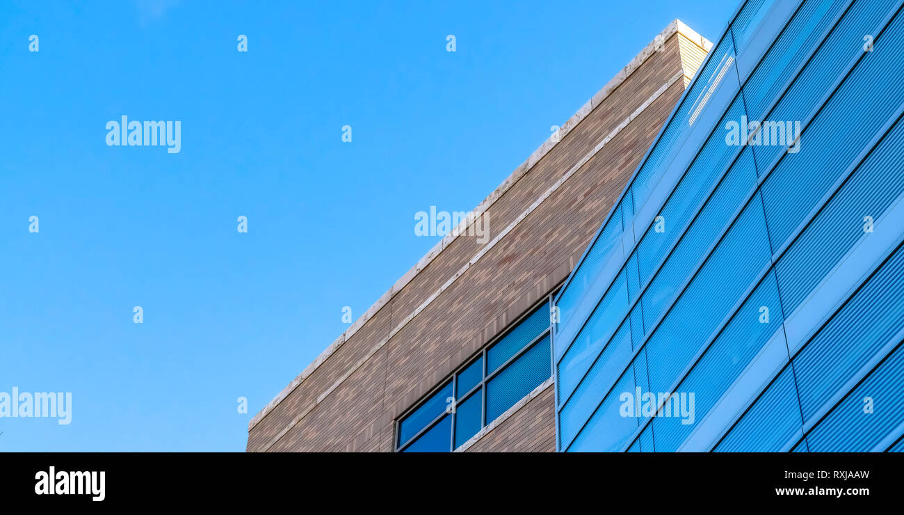 Blue sky over building with blue glass windows Stock Photo - Alamy
