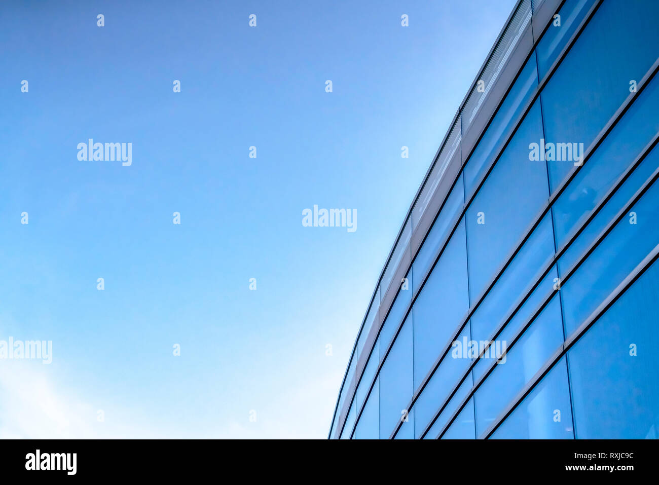 Modern building exterior with blue sky overhead Stock Photo - Alamy