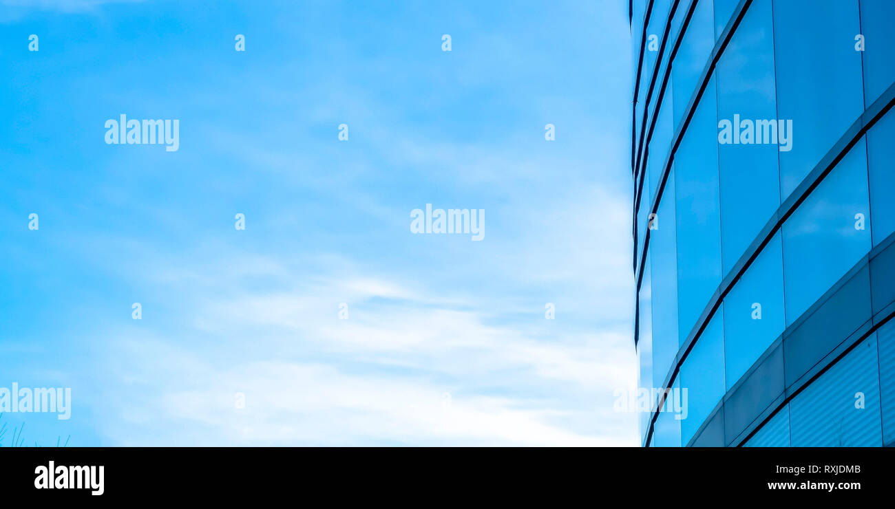 Reflective windows of building against bright sky Stock Photo - Alamy