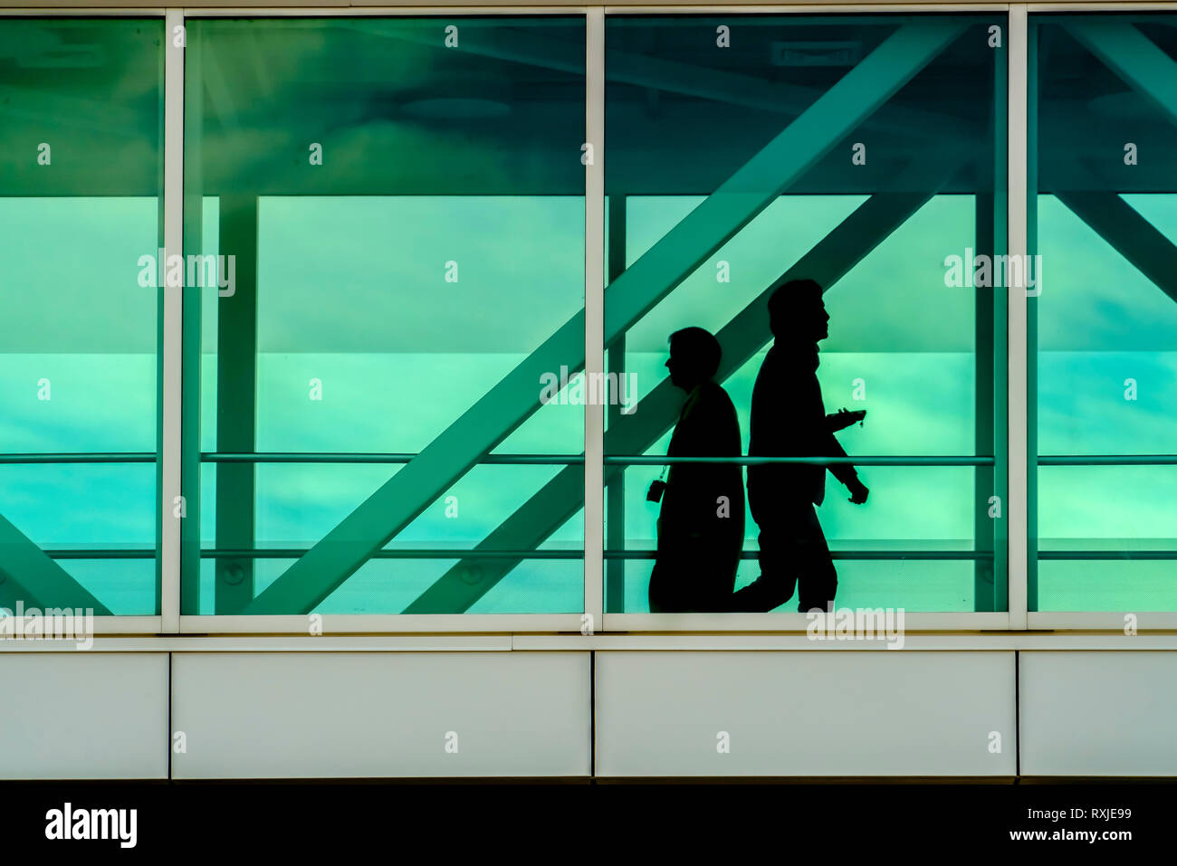 Silhouette of people seen through glass windows Stock Photo - Alamy