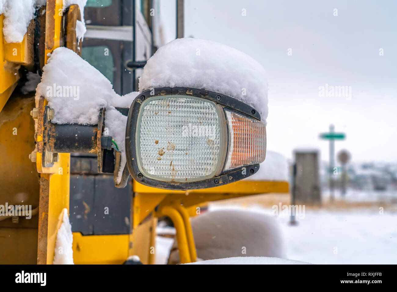 Snowy headlight of a construction vehicle in Utah Stock Photo - Alamy