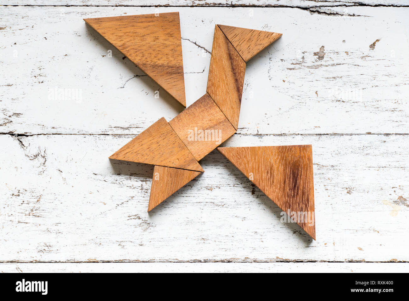 Tangram puzzle in flying bird shape on old white wood background Stock ...
