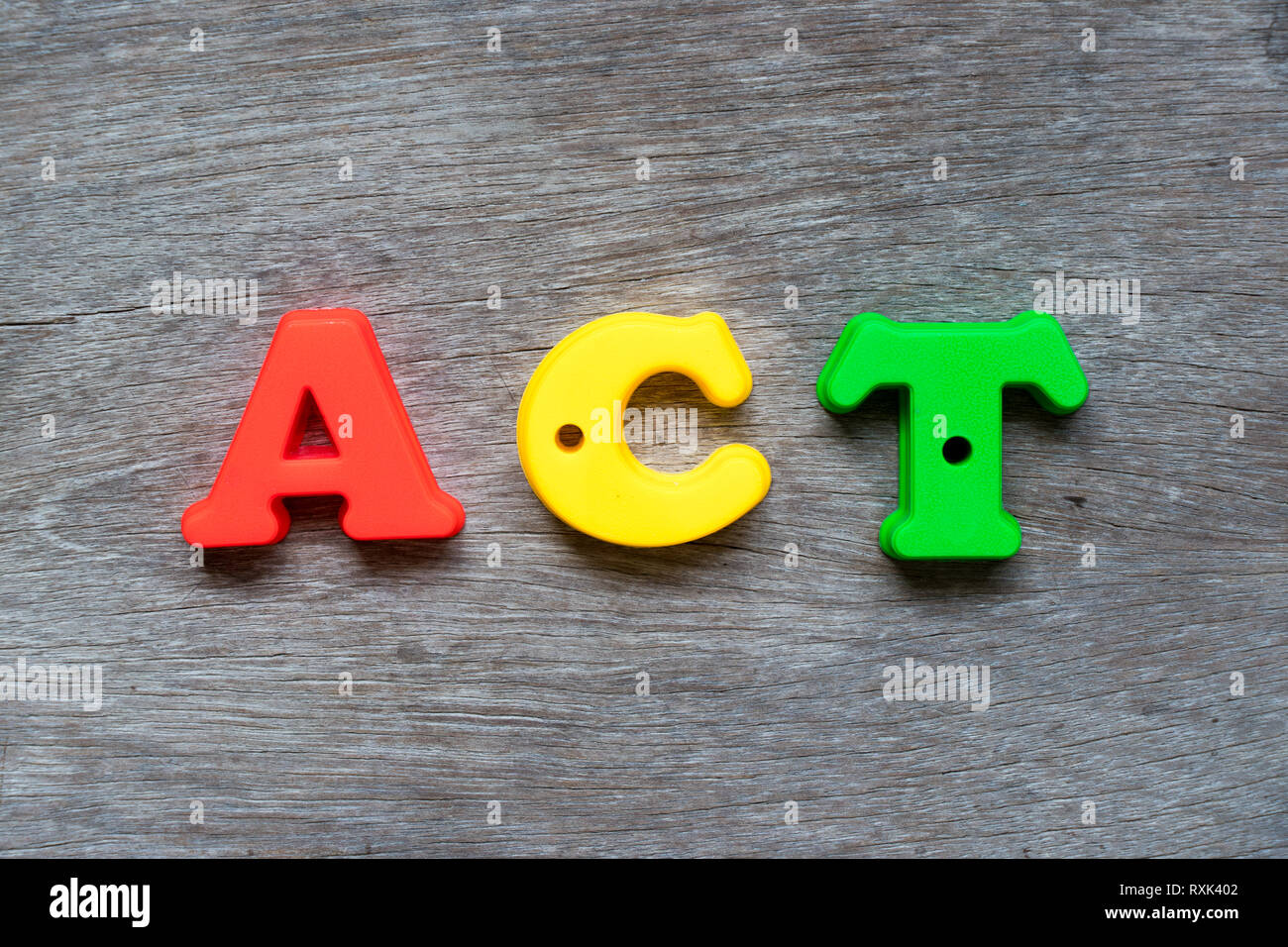 Colorful plastic alphabet in word act on wood background Stock Photo ...
