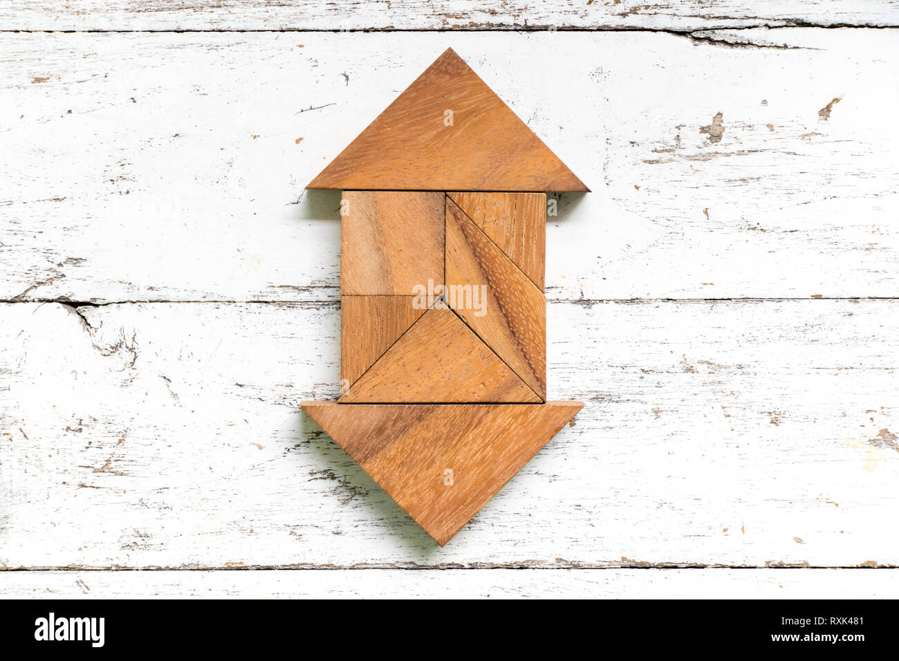 Tangram puzzle in 2 side arrow shape on old white wood background Stock ...