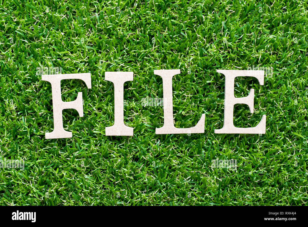 Wood alphabet in word file on artificial green grass background Stock ...