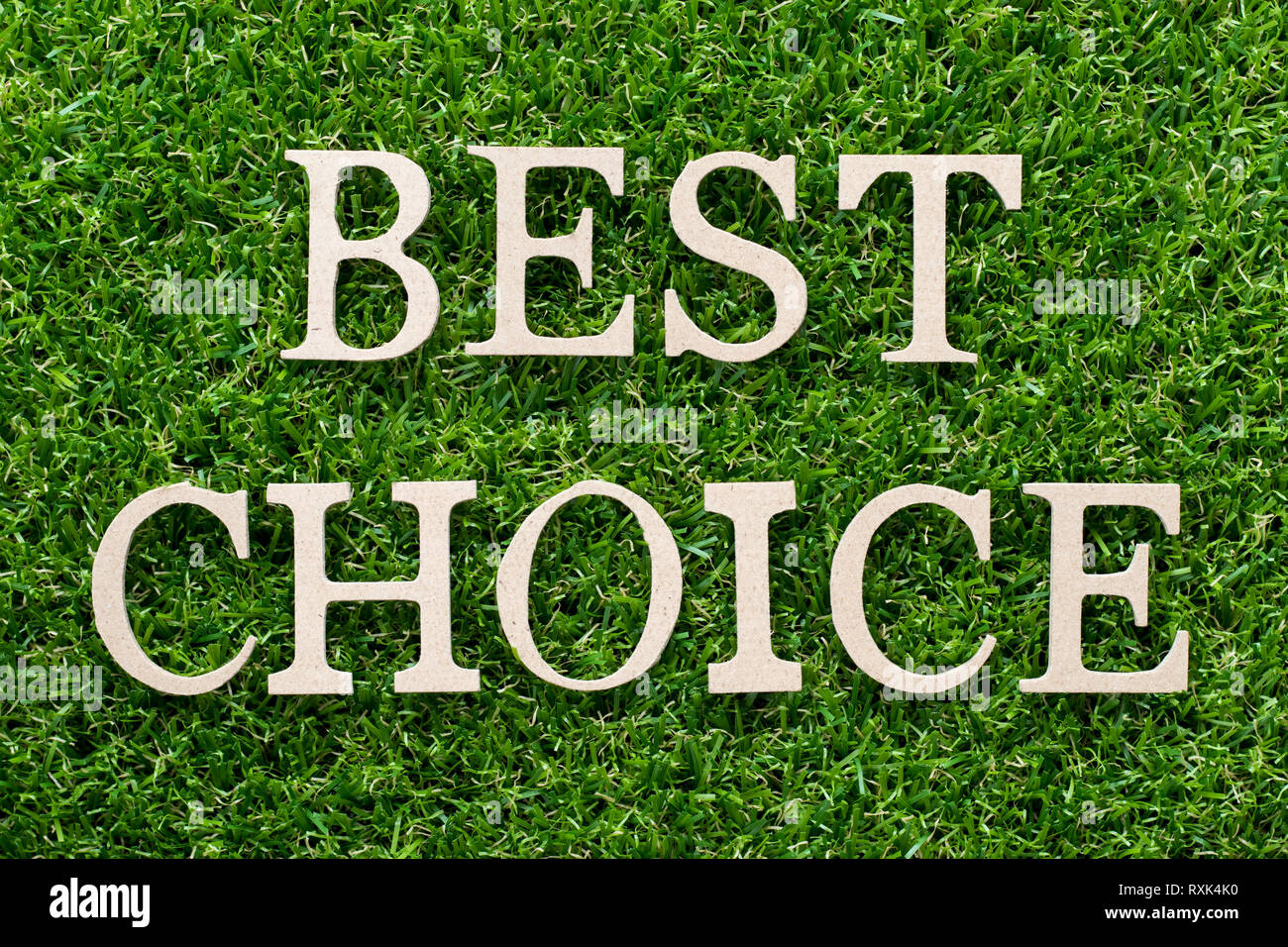 Wood alphabet in word best choice on artificial green grass background ...