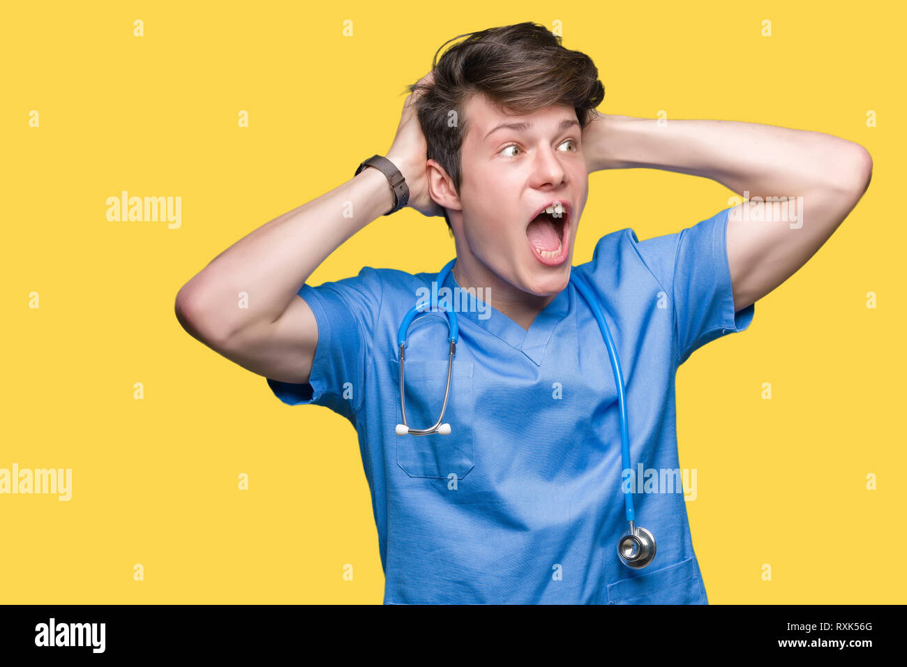 Young doctor wearing medical uniform over isolated background Crazy and ...
