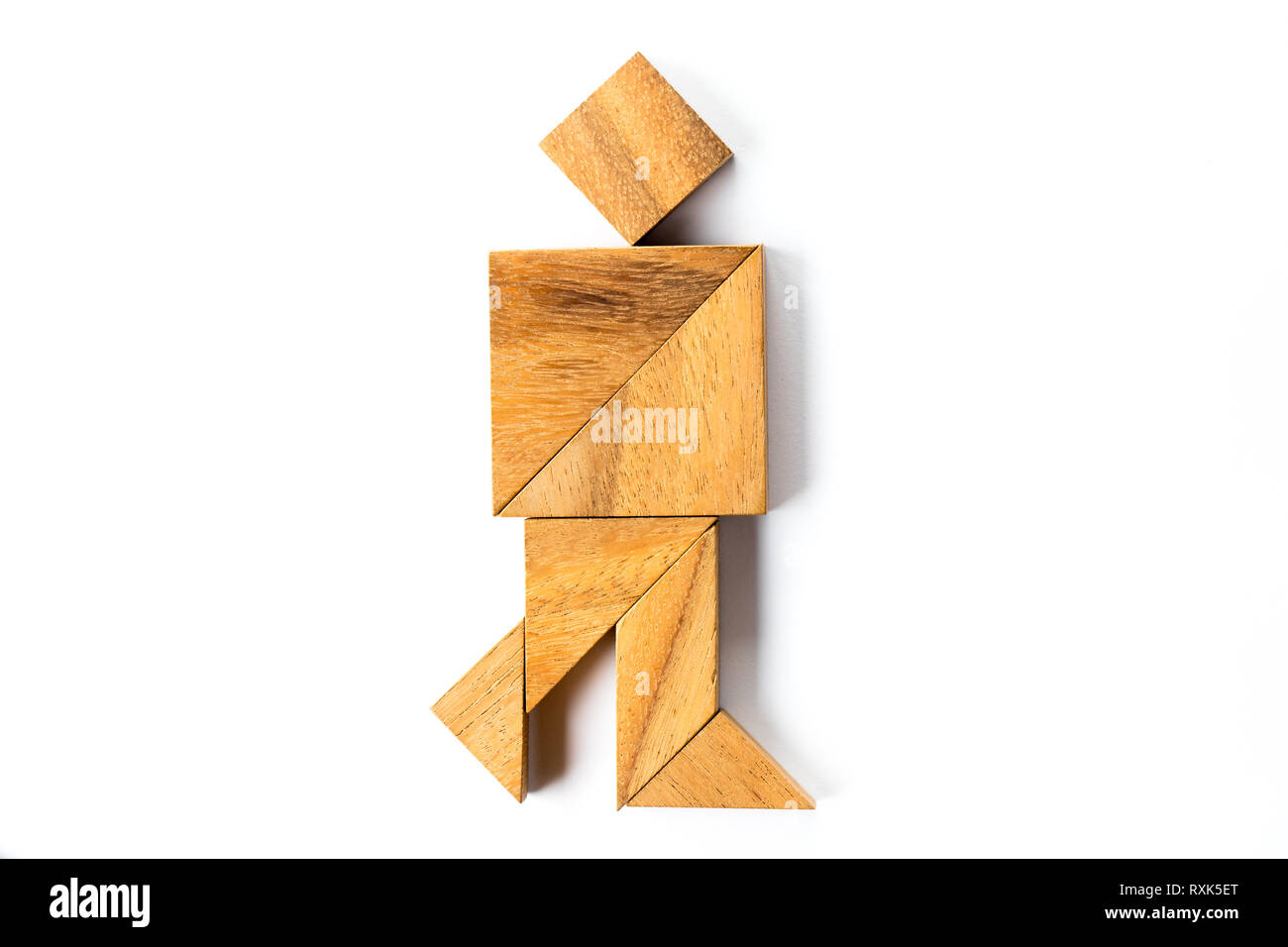 Wood tangram puzzle in man walking shape on white background Stock ...