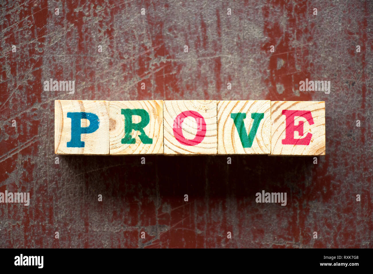 Letter block in word prove on old red wood background Stock Photo - Alamy