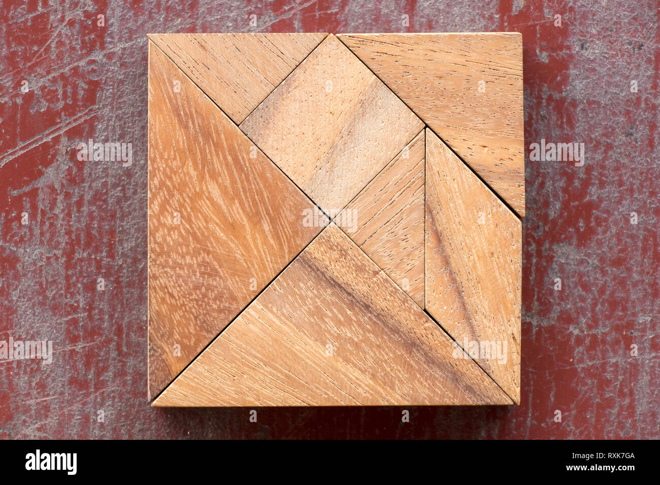 Tangram puzzle in square shape on red old wood background Stock Photo ...