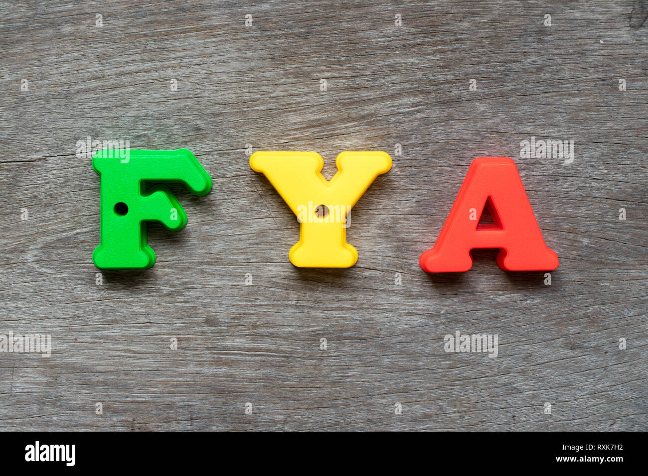 Colorful plastic alphabet in word FYA (Abbreviation of For your action ...