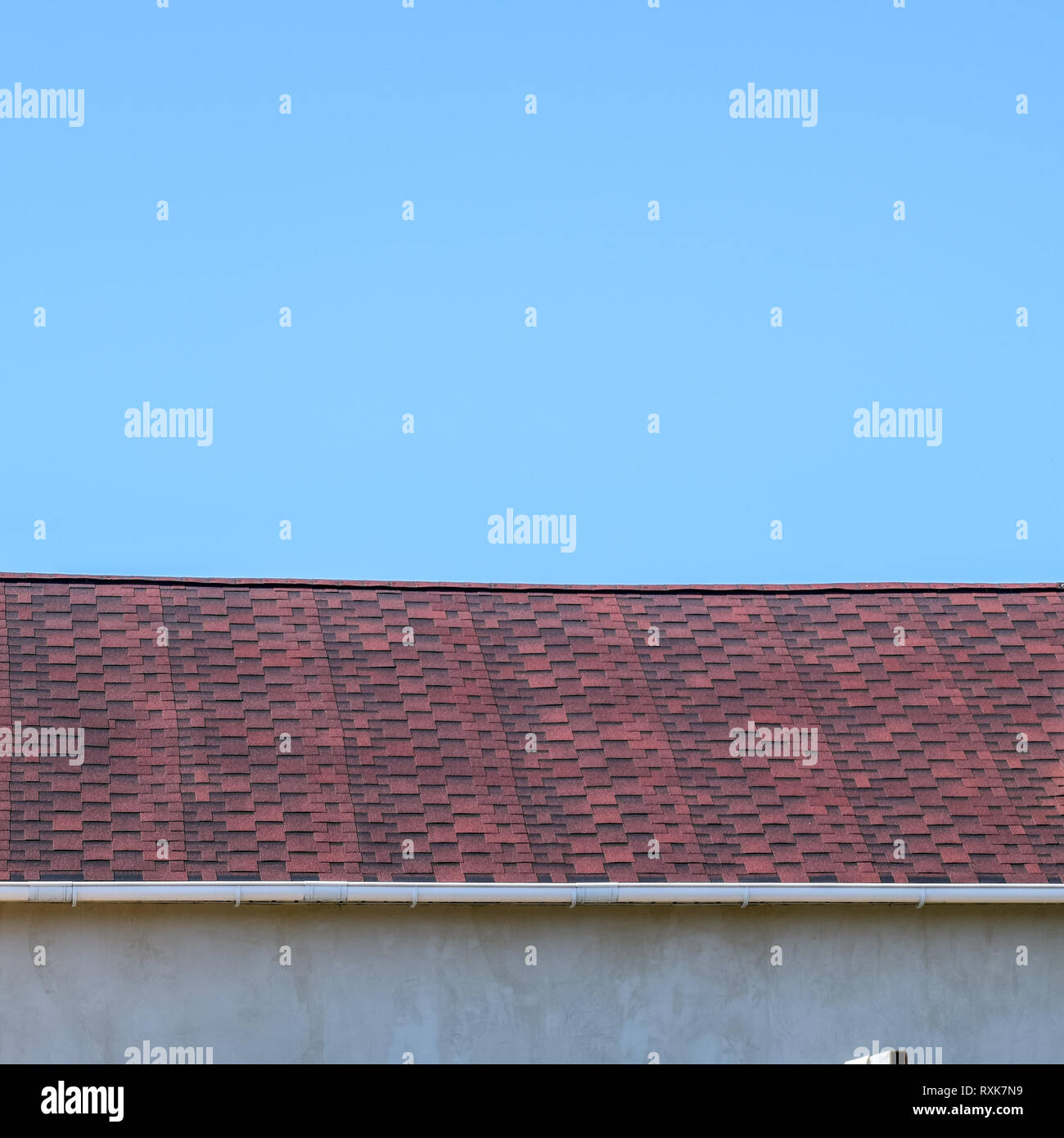 Bituminous burgundy roof. Roof from multi-colored bituminous shingles ...