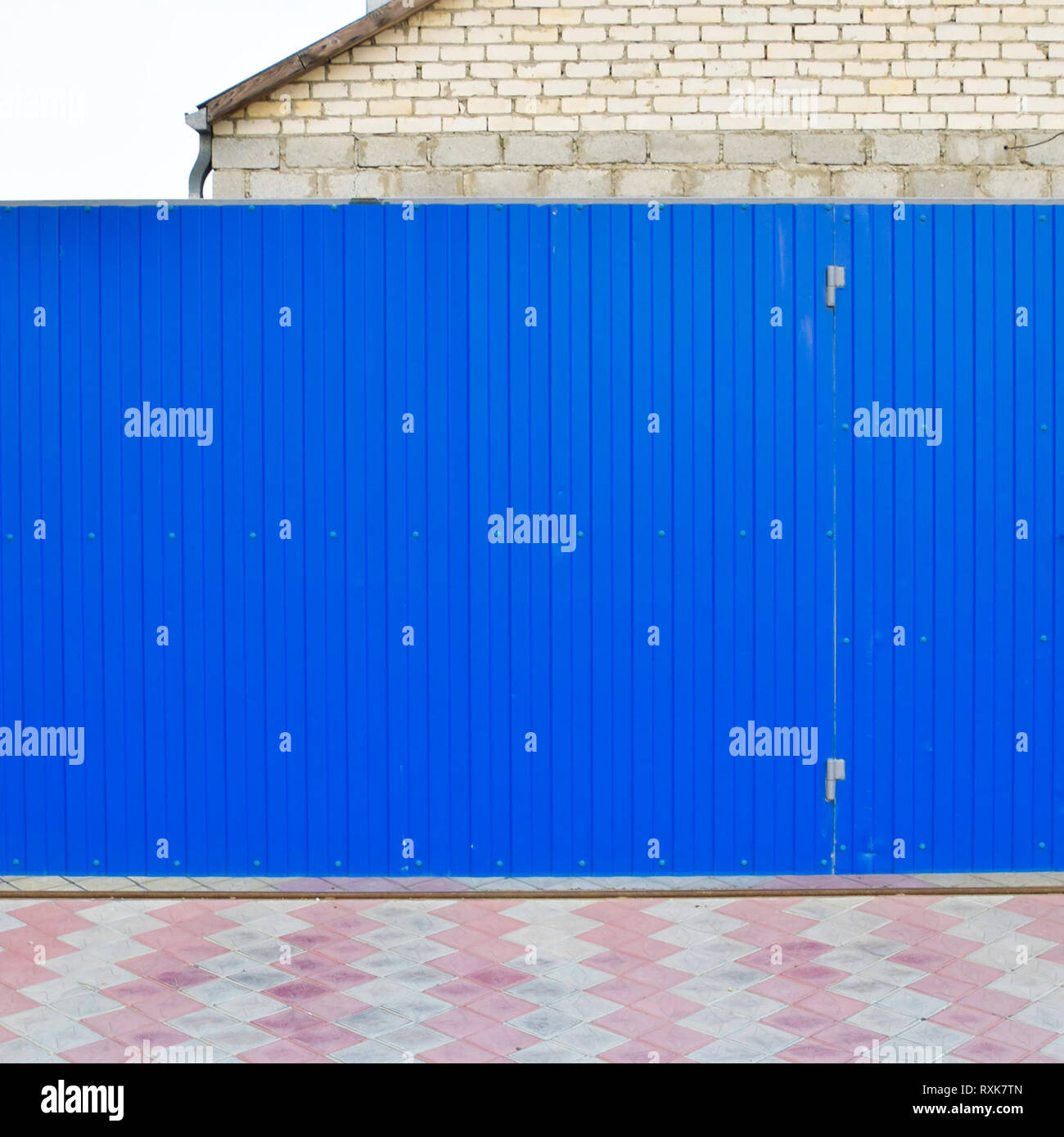 Blue gate and fence. Fence of the private house with blue fence and a ...