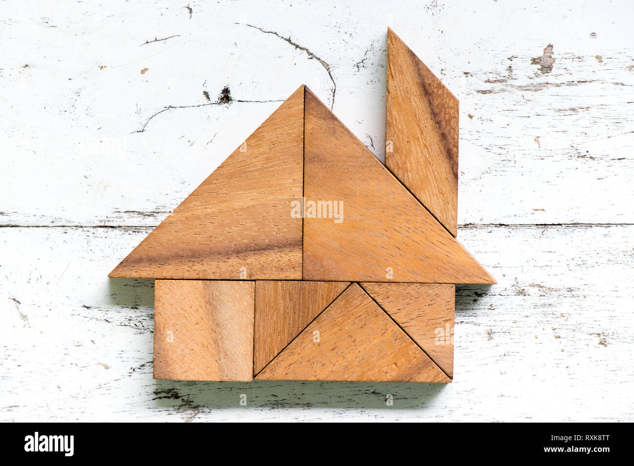 Tangram puzzle in home shape on old white wood background Stock Photo ...