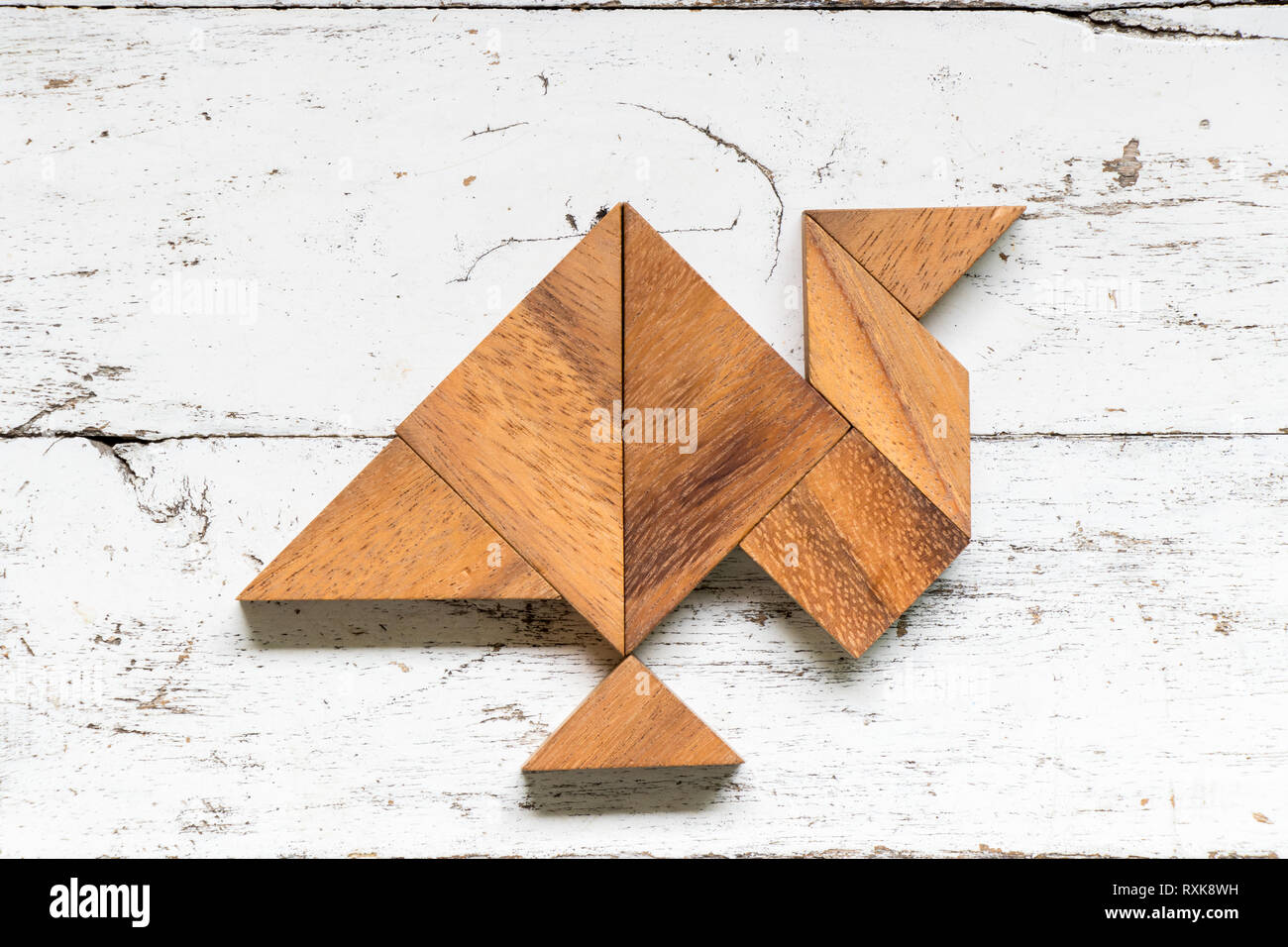 Tangram puzzle in vulture or turkey shape on old white wood background ...