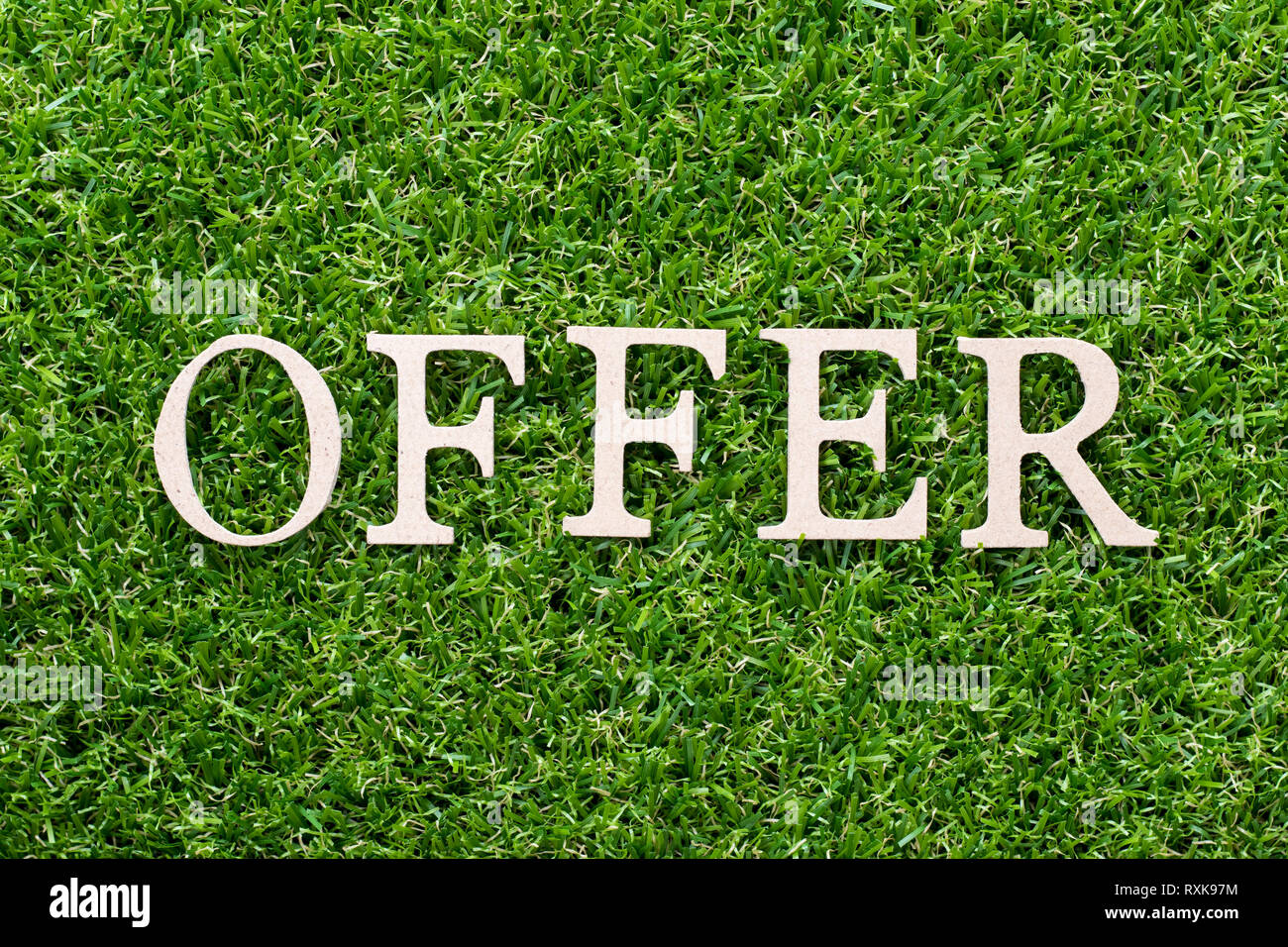 Wood alphabet in word offer on artificial green grass background Stock ...
